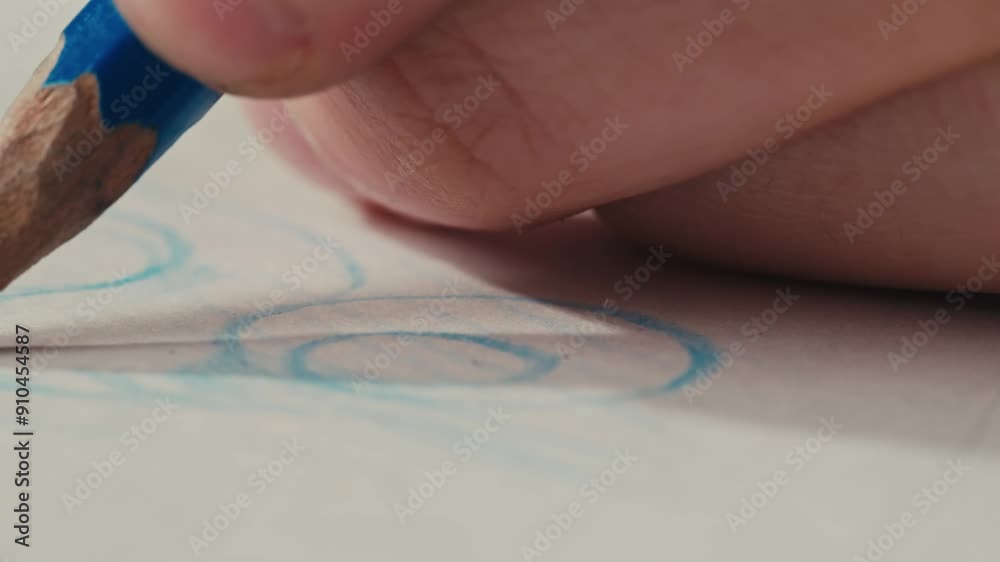 Close-up of blue colour pencil drawing on white paper macro. The ...