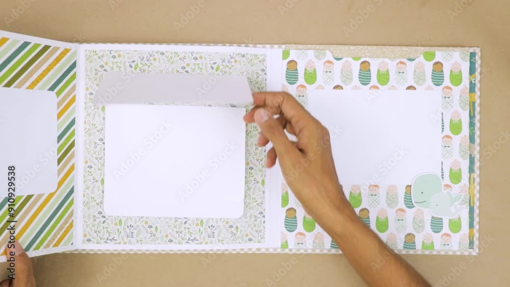 Flipping pages of baby themed scrapbook album, layout different ...