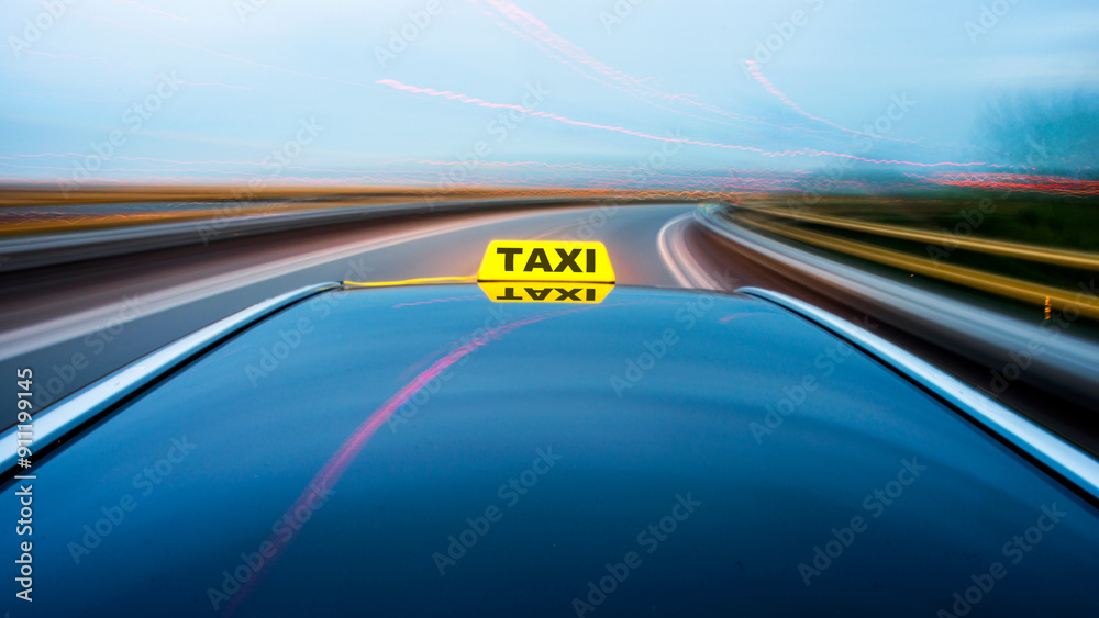 Taxi cab moving along a road, approaching a curve on a motorway exit ...