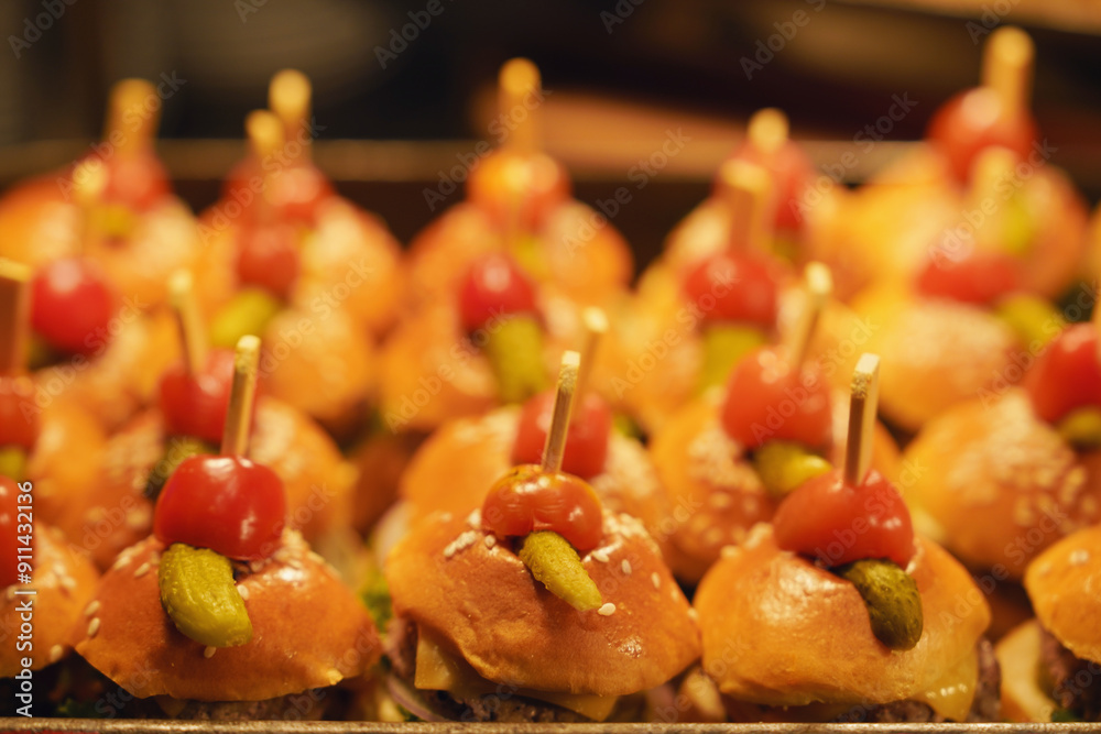 Mini hamburger snacks for dinner on a tray in a hotel buffet. Junk food ...