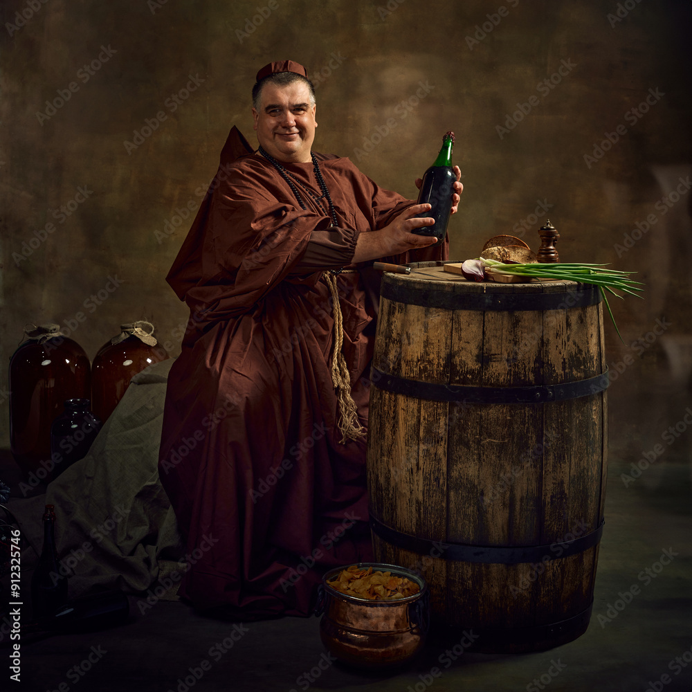 Mature man, medieval monk in period attire sitting with smile and ...