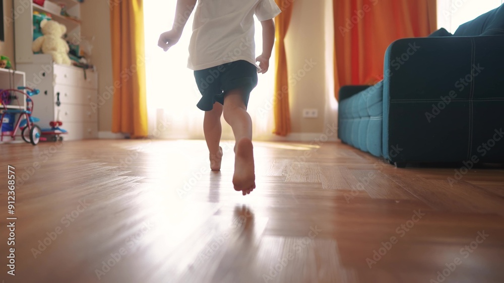 Bare feet run. child is running indoors at home. Children happy family ...