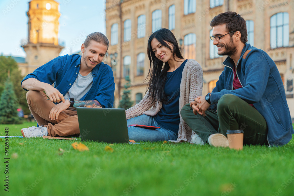 College students friends classmates sitting on the grass near ...