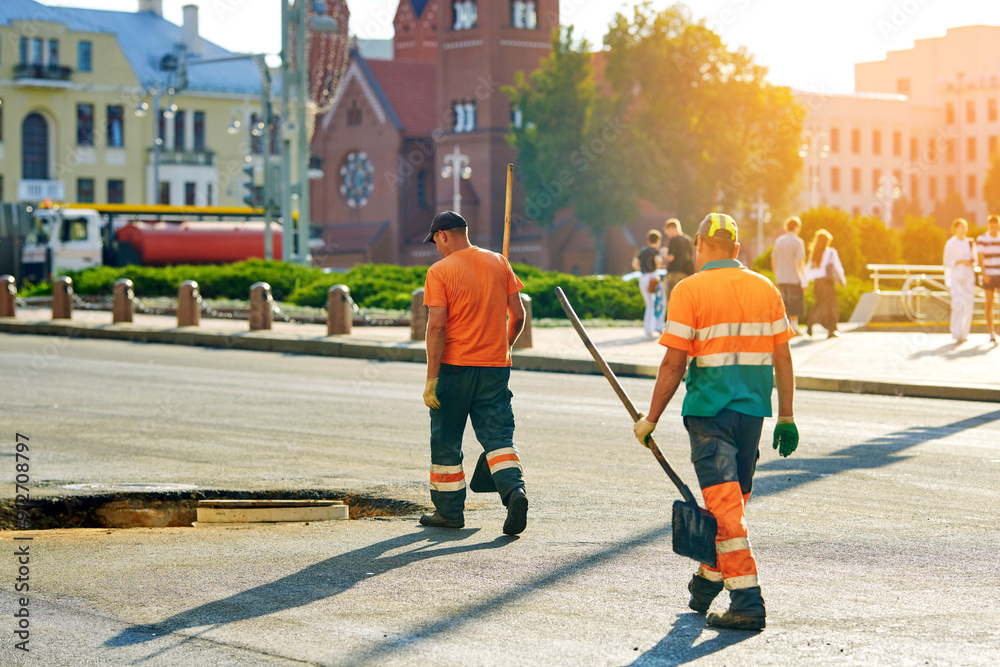 Road construction workers with shovels, maintenance crew. Road repair ...