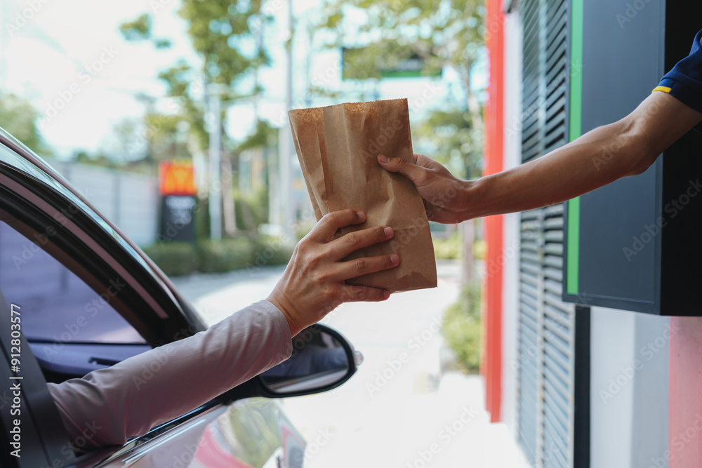 Men are picking up food from drive-thru counters and taking it out to ...