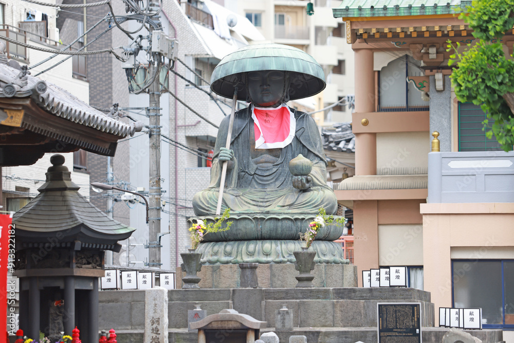 Tokyo- May 5 2024: a statue of Ksitigarbha, Jizo Bodhisattva sitting ...