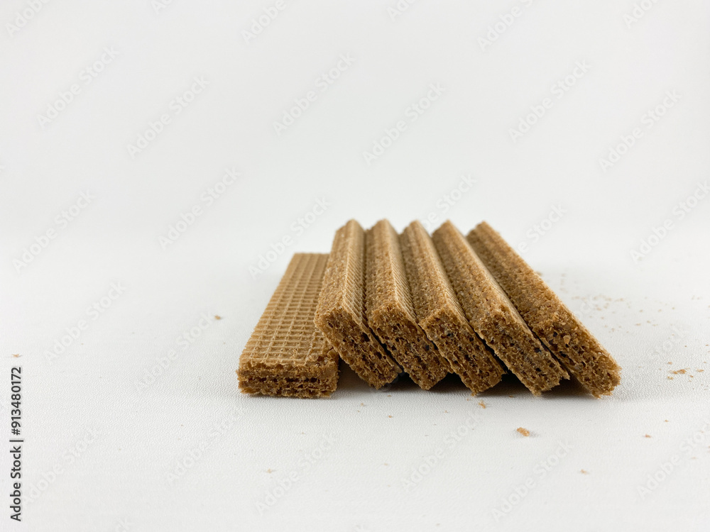 crispy wafer sticks arranged in a staggered pattern on a white ...