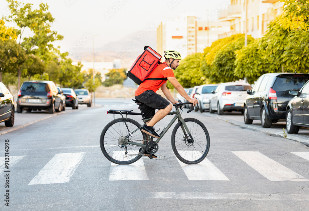 A 40-year-old delivery man delivers fast food on a modern bicycle and ...