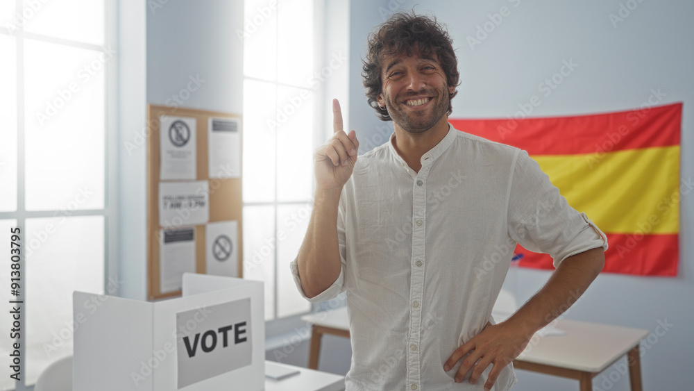 Young man voting in an indoor electoral college room with a spanish ...
