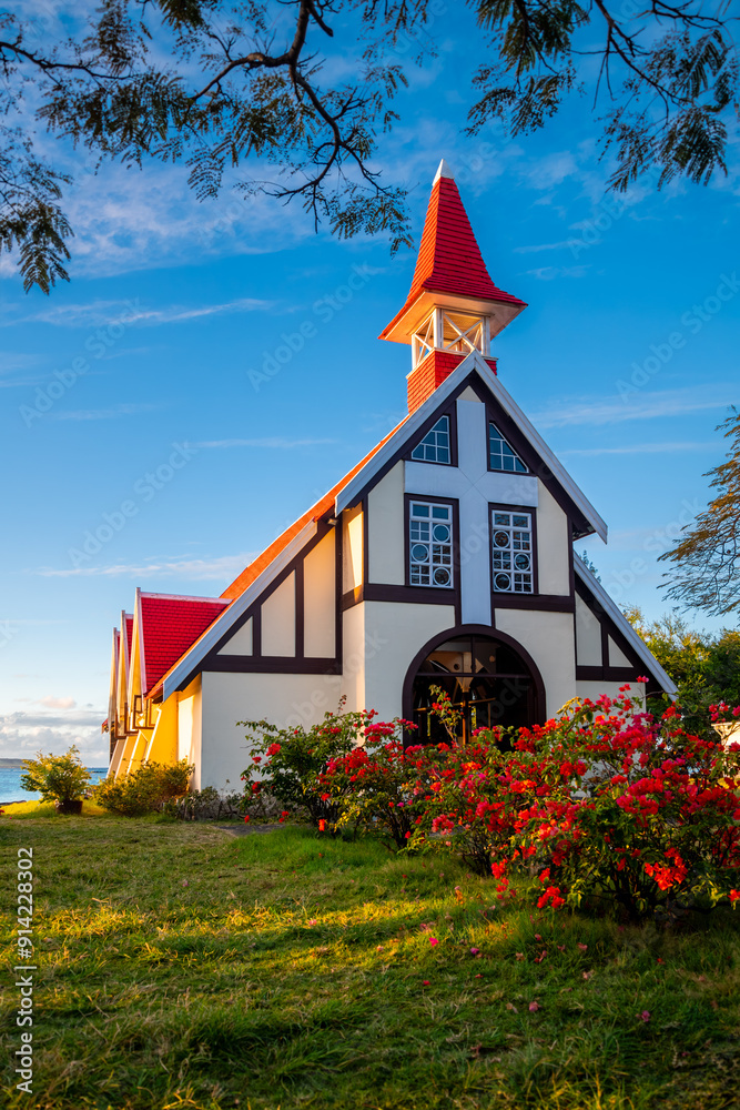 The old wooden chapel "Notre-Dame Auxiliatrice" with its red roof and ...