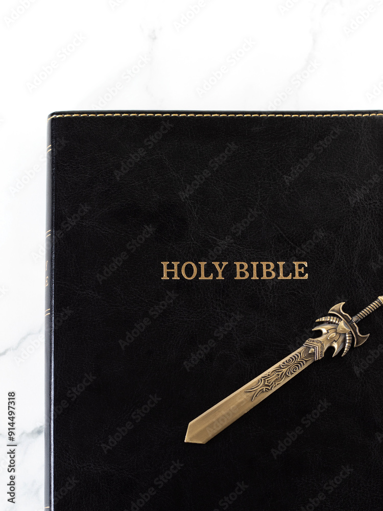 Ancient sword on top of Christian holy bible book. Top view. Biblical ...
