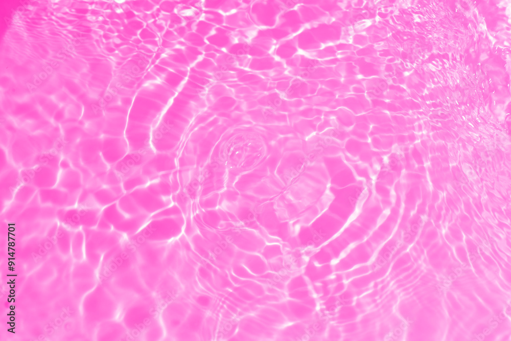 Pink water bubbles on the surface ripples. Defocus blurred transparent ...