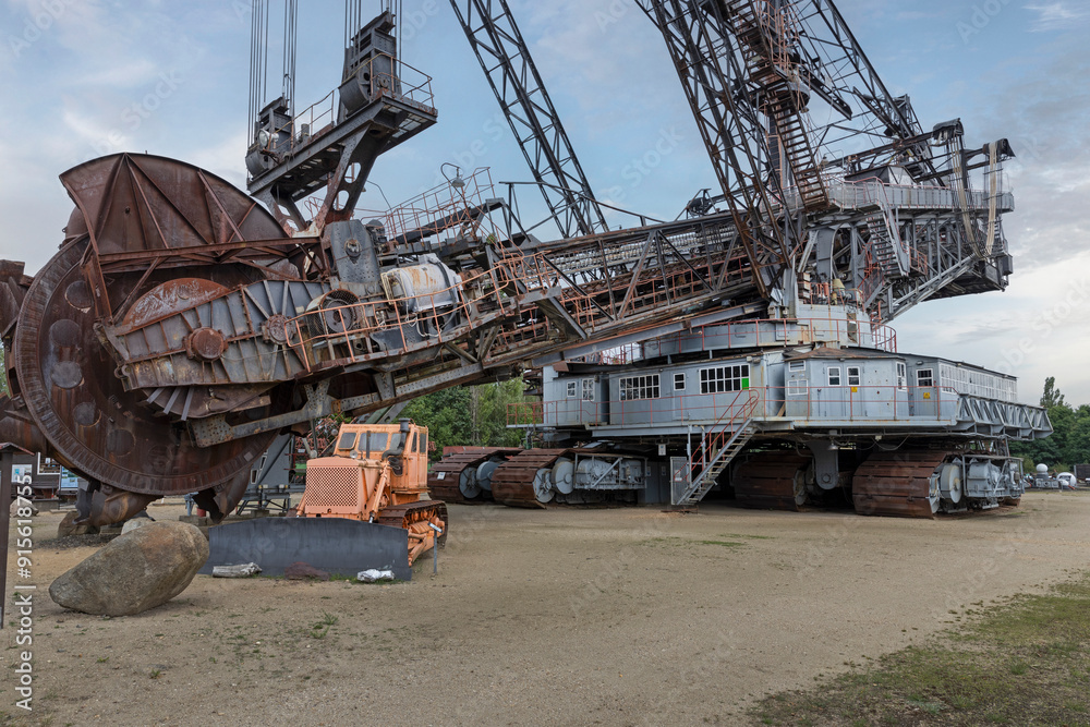 Caterpillar buldozer and Lignite mining digging crane. Industrial ...