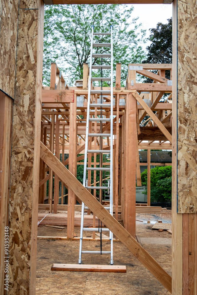 Interior new house construction at wood framing stage, aluminum ...