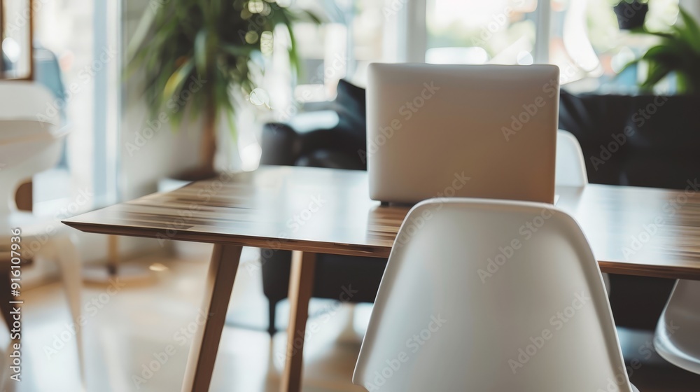Imagine a minimalist workspace with a laptop on a sleek modern table ...