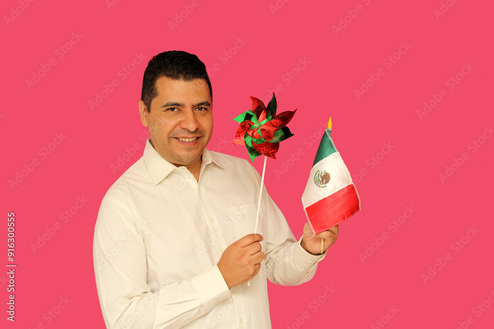 40-year-old dark-skinned Mexican man blows to spin a tricolor pinwheel ...