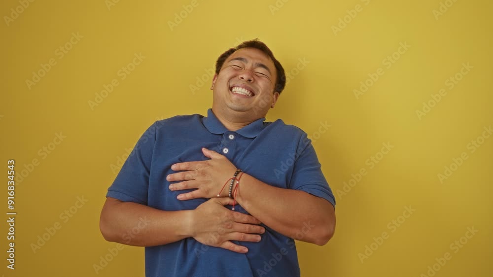 Laughing, young chinese man standing, smiling and laughing hard out ...