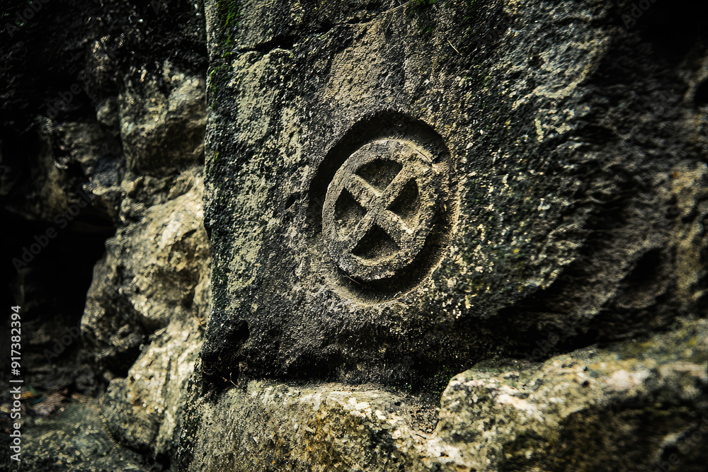 Ancient cryptic symbol etched into a weathered stone wall, hinting at ...