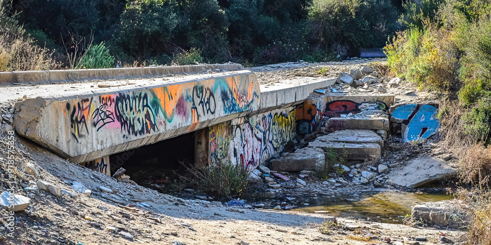 Broken Bridges: A collapsed concrete bridge, with graffiti on the ...