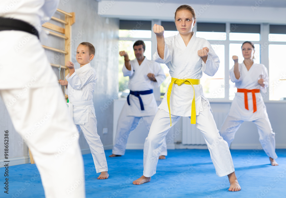Teen girl and her family repeat movements and learn fighting techniques ...