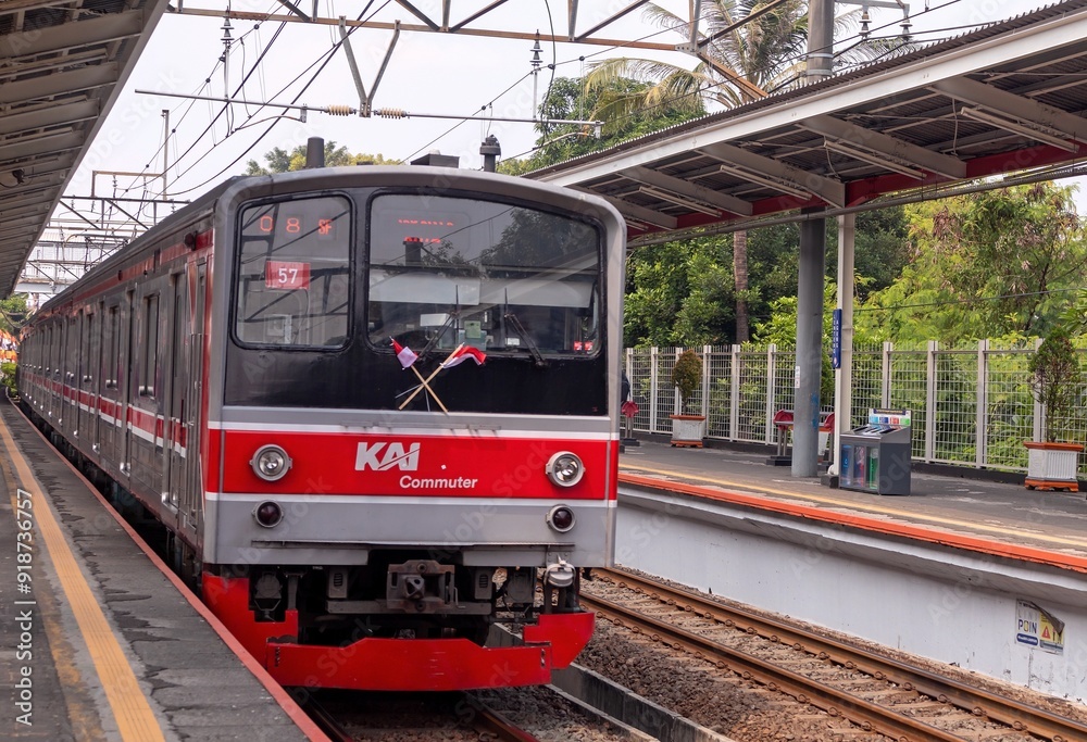 Jakarta, Indonesia - August 10, 2024: The commuter line train stop at the station. Mass public ...