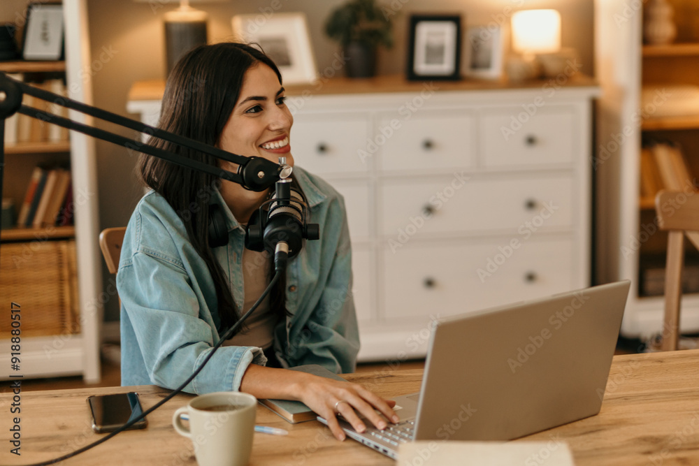 Female content creator using a laptop and mic and announcing new ...