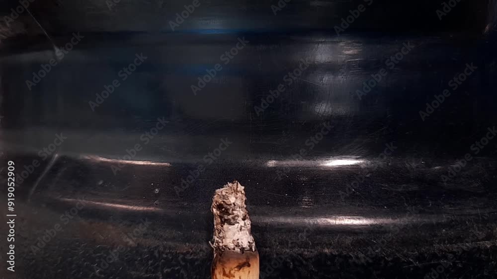 Thin smoke rising from a cigarette, cigarettes placed carelessly are ...