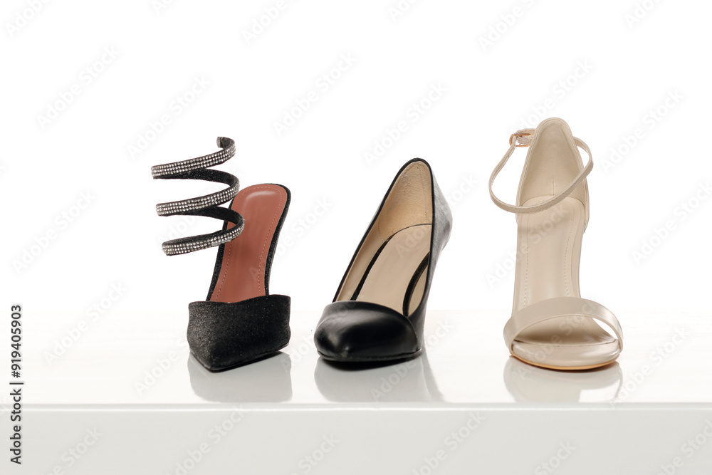 Front view of a three different models of shoes with high heels on a ...