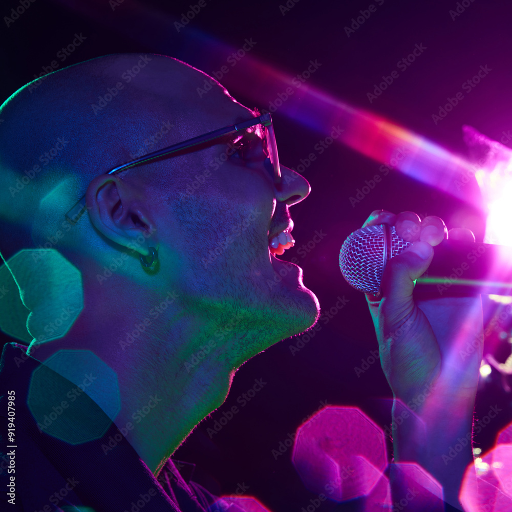 Neon hues reflect off singer's face as he belt out powerful note ...