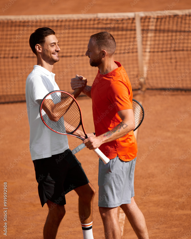 Friendly positive handshake between two male tennis players celebrating ...