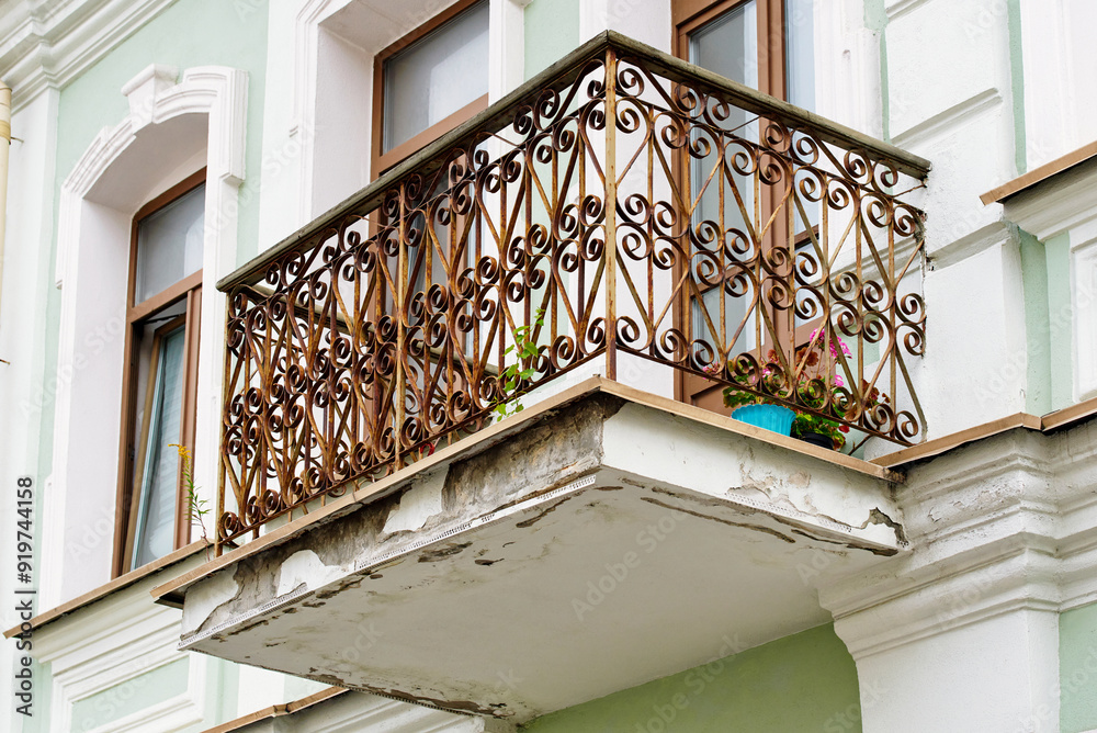 Old balcony with rusty railings and damaged plaster needs for repair ...