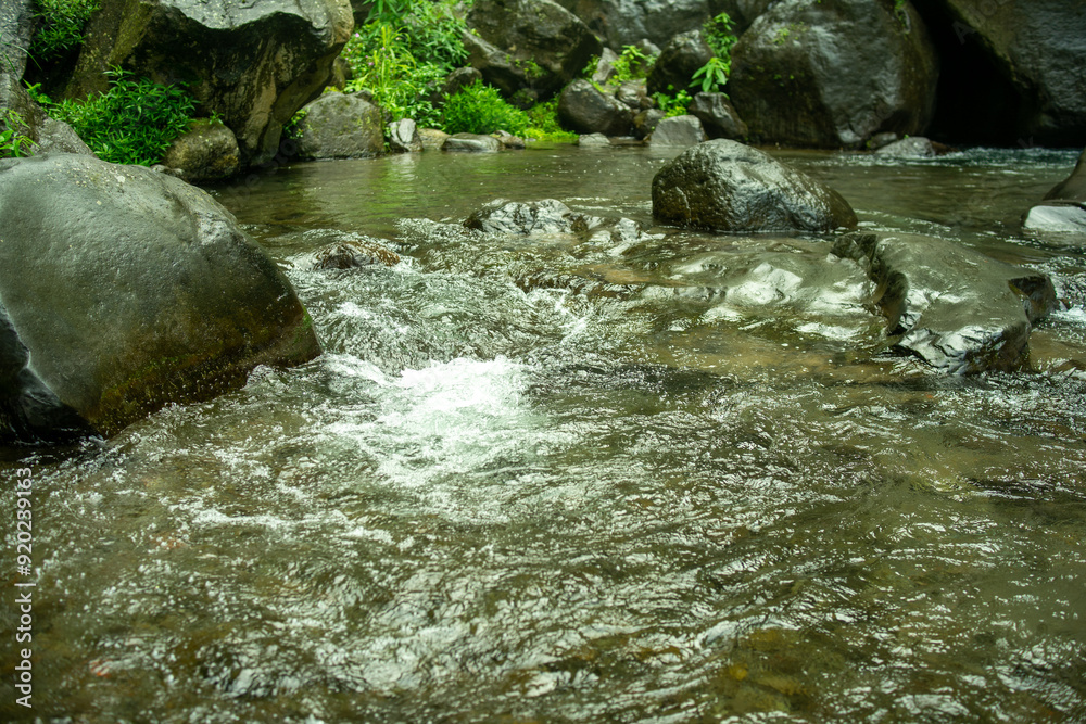 Flowing river water movement between mountain rocks in close-up ...