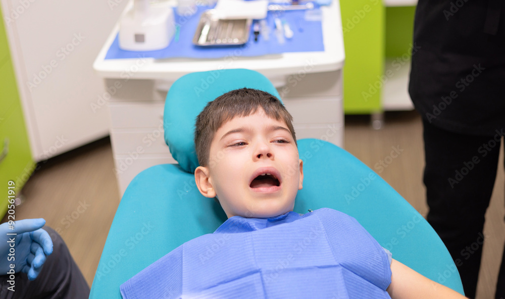 kid in dental office. dentist checking child teeth using tools mouth ...
