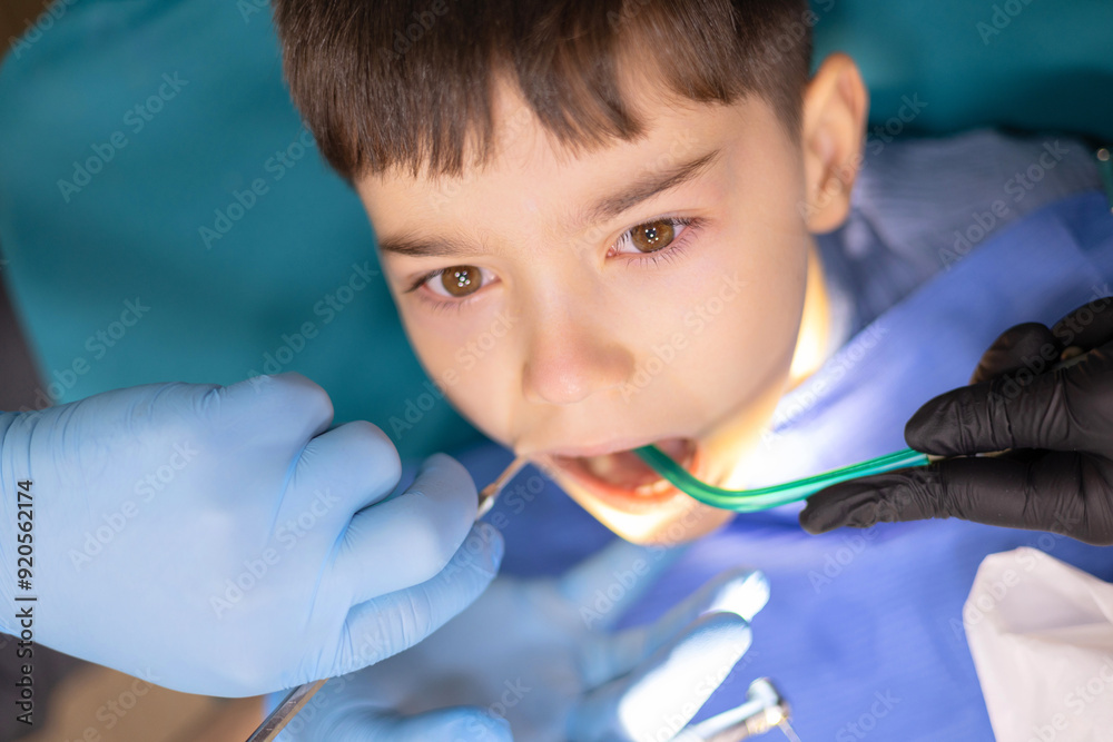 kid in dental office. dentist checking child teeth using tools mouth ...