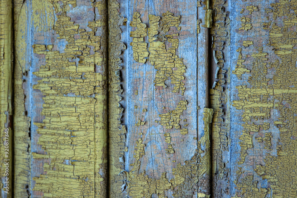 Rustic wood surface with chipped yellow paint and distressed blue layer ...