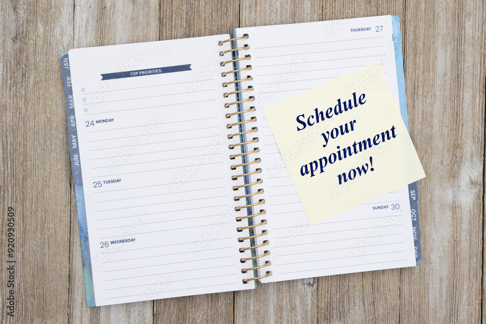 Schedule your appointment now with day planner and sticky note on a ...