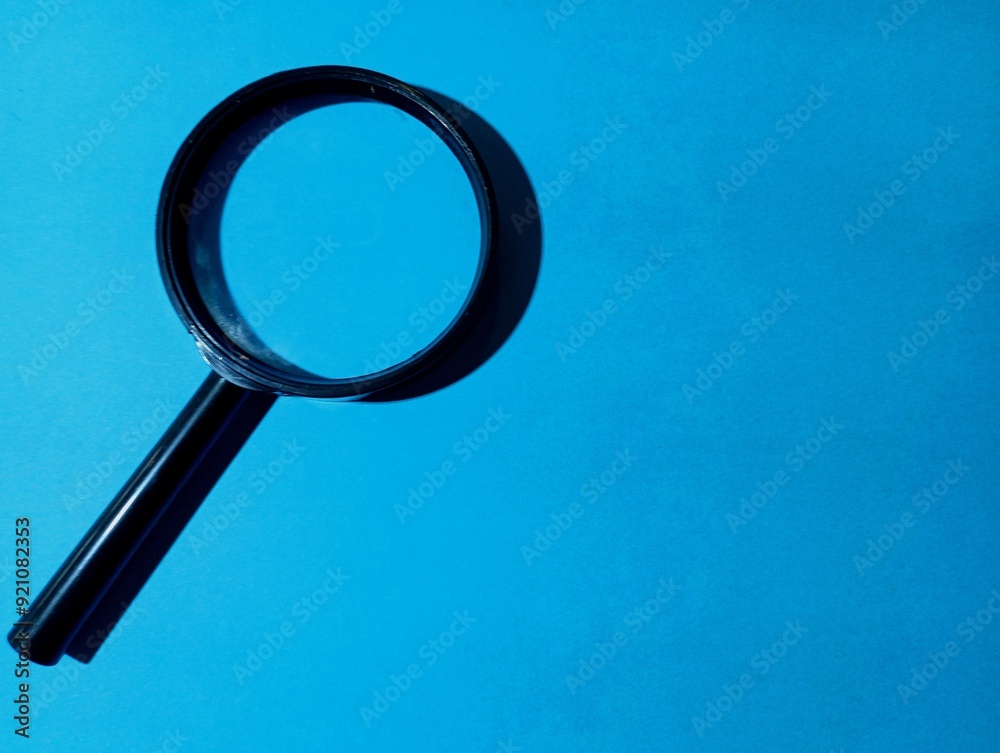 Magnifying glass on a blue background. A special magnifying glass for ...