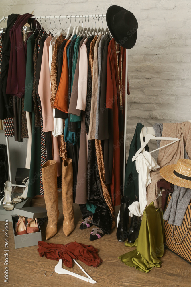 Untidy cluttered woman wardrobe with stylish clothes and accessories ...