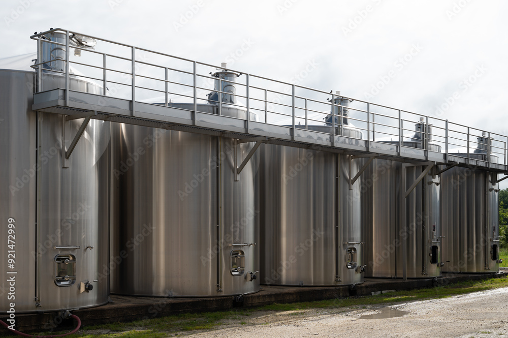 Works at distillery in Cognac white wine region, Charente, steel tanks ...