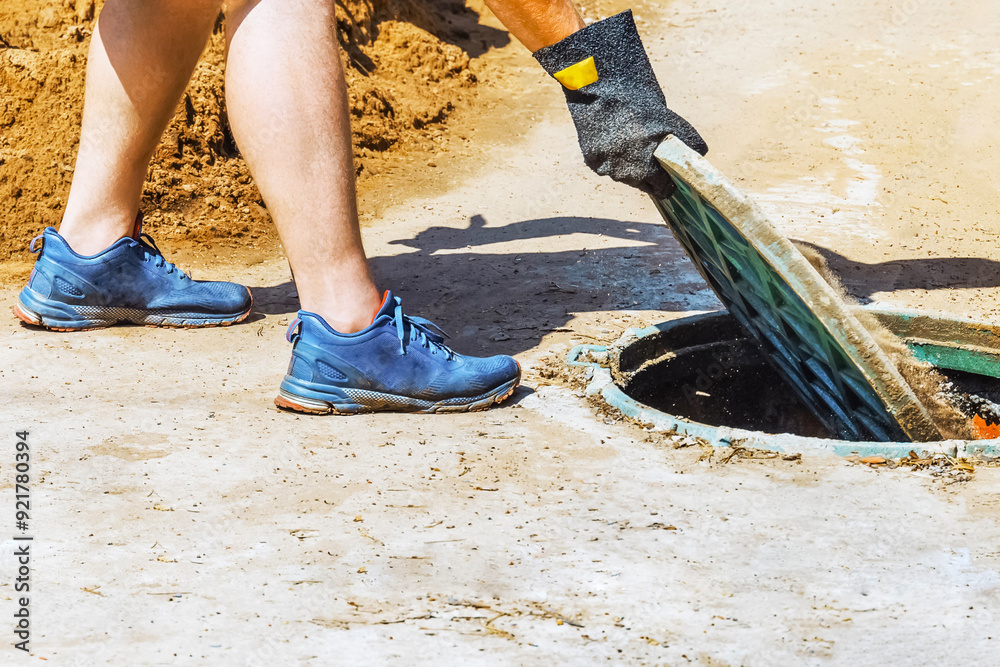 man pumping out house septic tank. drain and sewage cleaning service ...