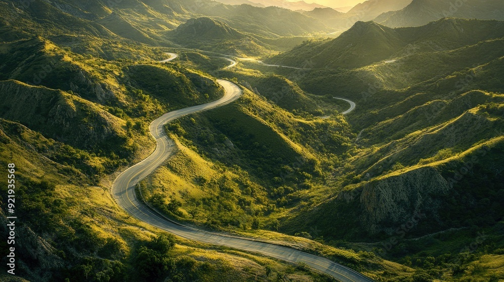 Top view of a winding road through rolling hills and mountainous ...