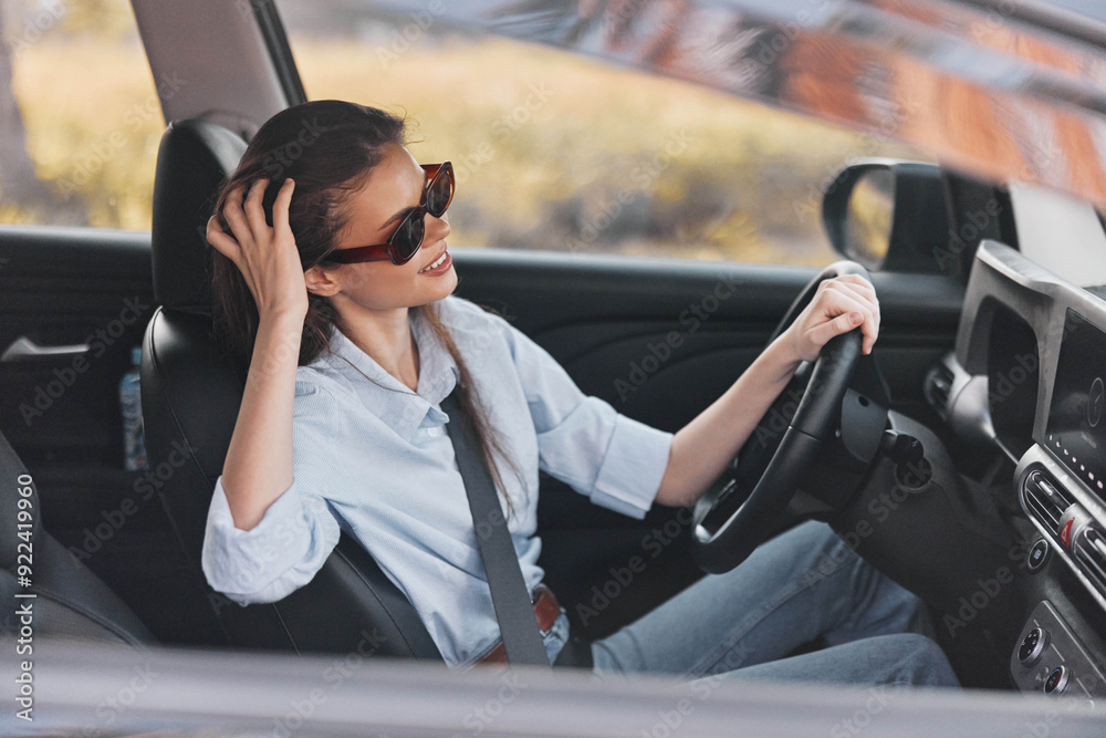 Sad woman sitting in car with head on steering wheel and hands on her ...