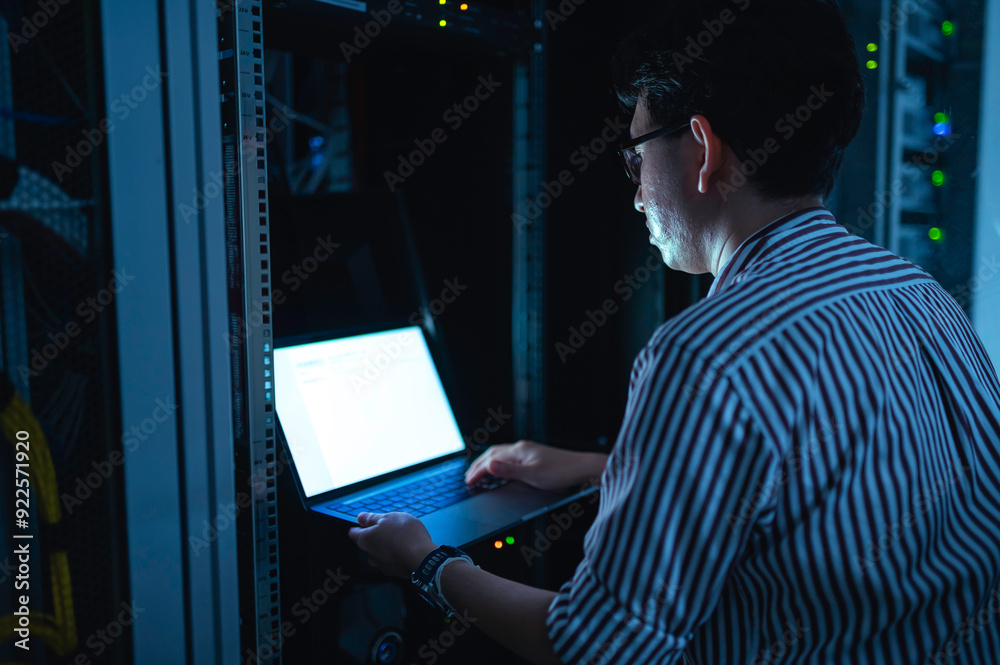 Computer engineer is setting up network in server room,Systems ...