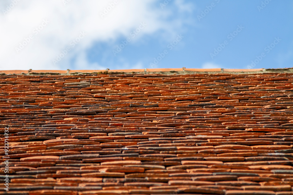 Old traditional roof of an English cottage features orange slate tiles ...