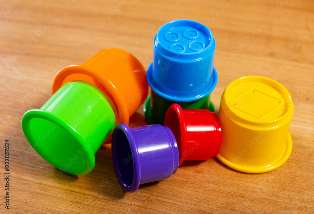 Childrens toy plastic cup pyramid made of multicolored elements. Parts ...