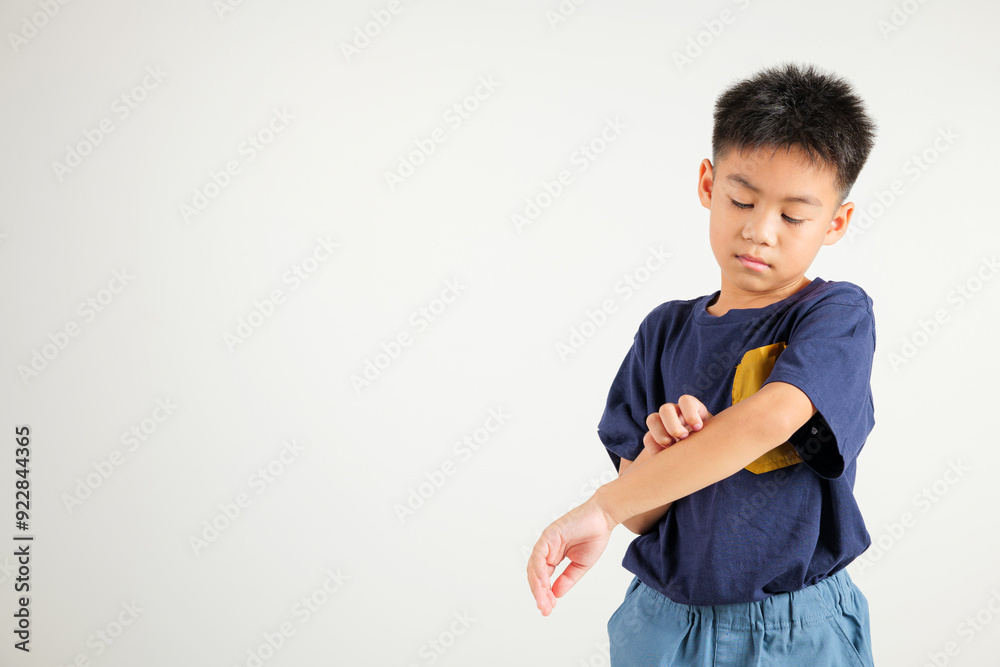 Asian little kid boy scratching itchy arm from a mosquito bite at ...