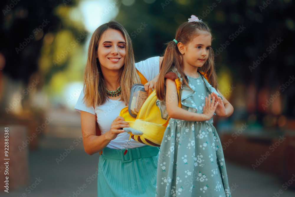 Mom Checking the Lunch Box is in the School Bag. Adorable kid receiving ...
