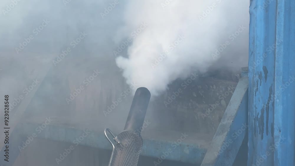 Fogging activity to kill mosquitoes. Fogging machine with insecticide ...