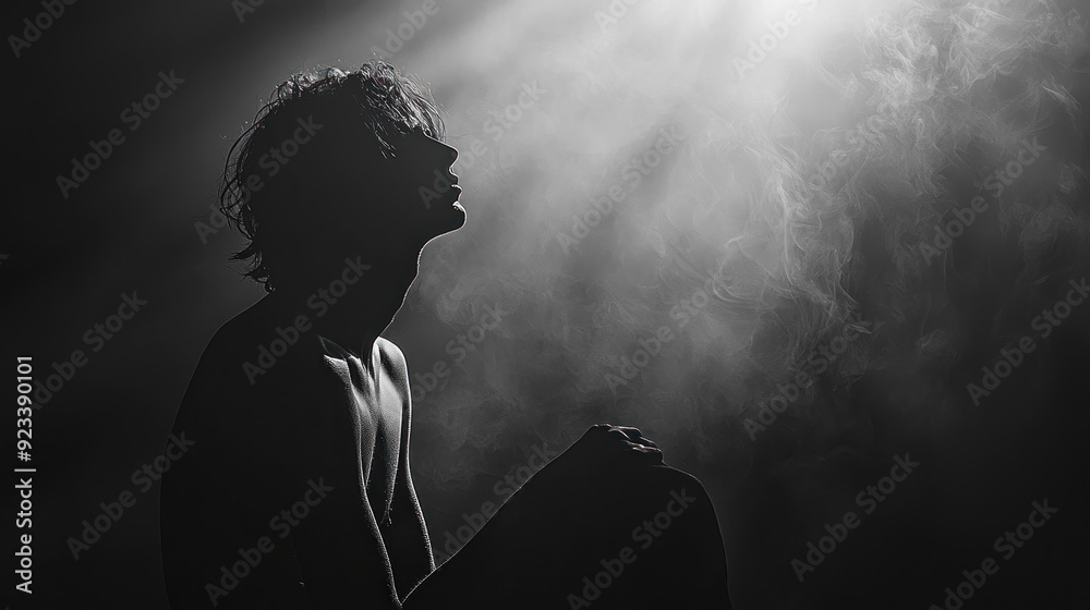 Dark-themed portrait of a person in deep thought depicted against a ...