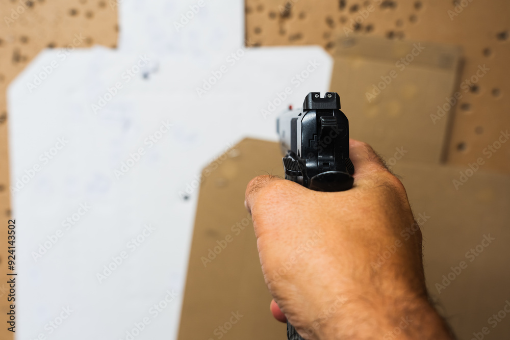 Shooting from a pistol at targets in the shape of a body silhouette in ...